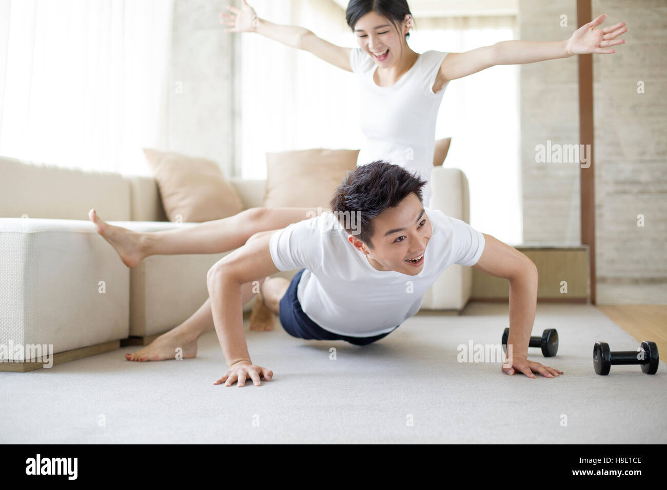 Young Chinese couple exercising at home Stock Photo - Alamy