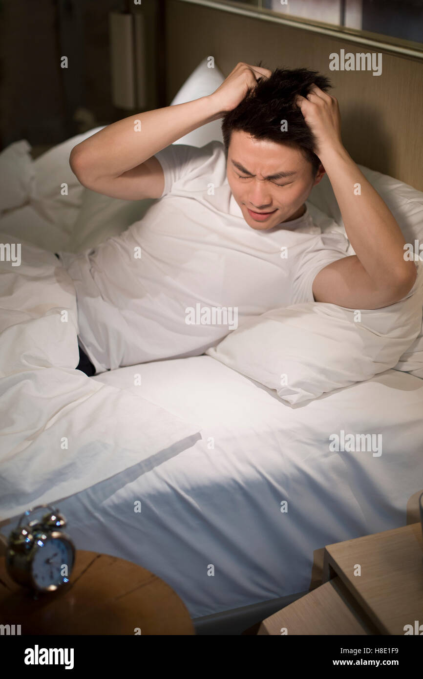 Young Chinese man suffering from insomnia Stock Photo - Alamy