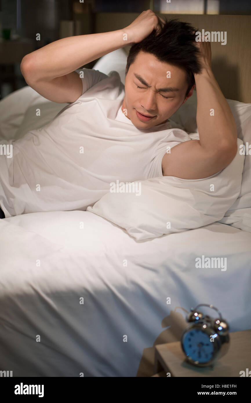 Young Chinese man suffering from insomnia Stock Photo - Alamy