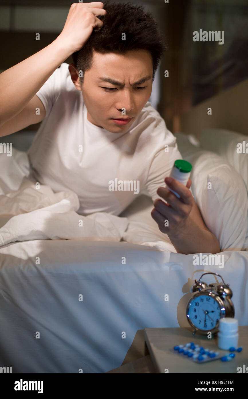 Young Chinese man suffering from insomnia Stock Photo - Alamy