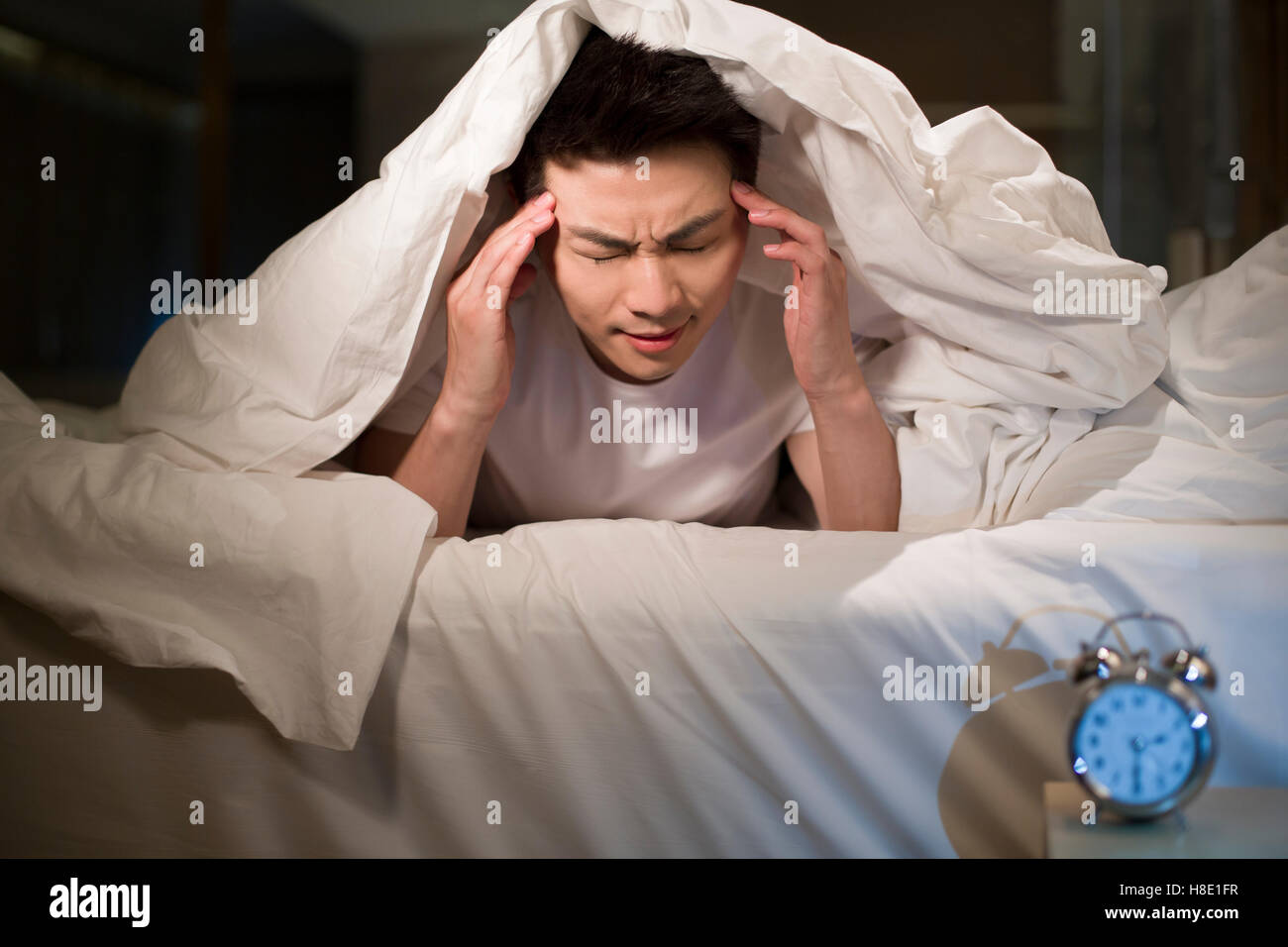 Young Chinese man suffering from insomnia Stock Photo - Alamy