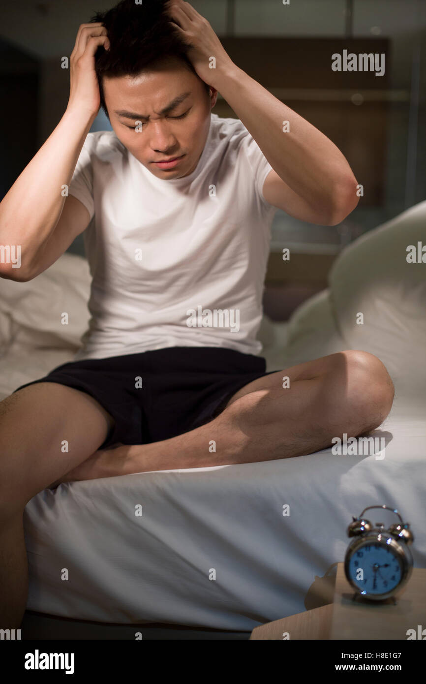 Young Chinese man suffering from insomnia Stock Photo - Alamy