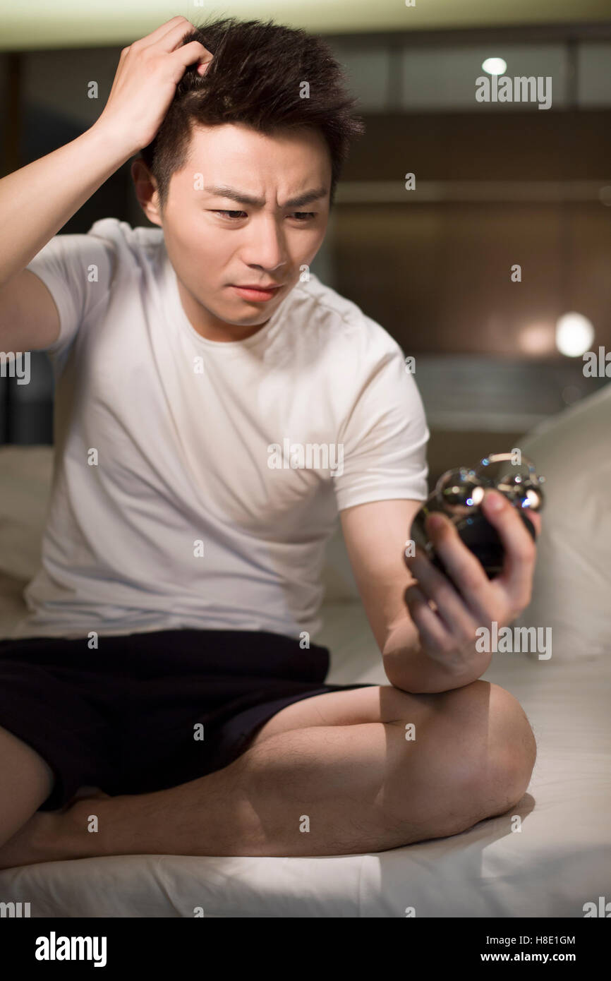 Young Chinese man suffering from insomnia Stock Photo - Alamy