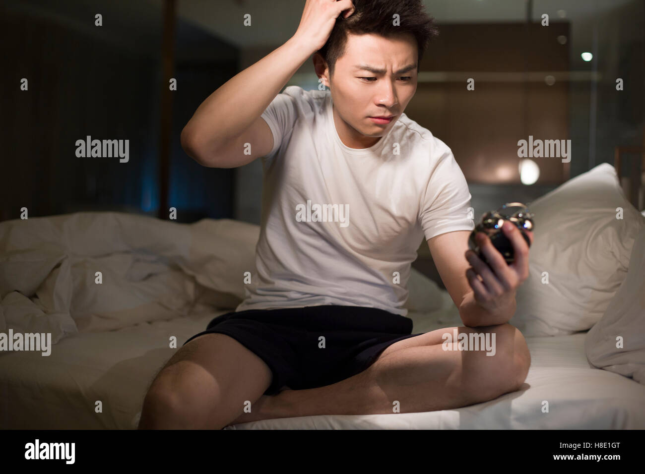 Young Chinese man suffering from insomnia Stock Photo - Alamy