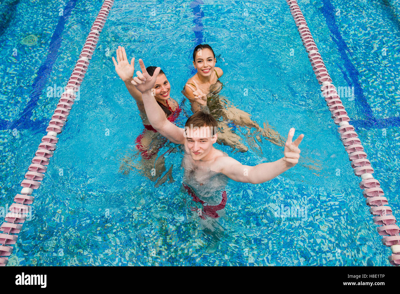 party in the swimming pool. three friends dancing indoors Stock Photo ...