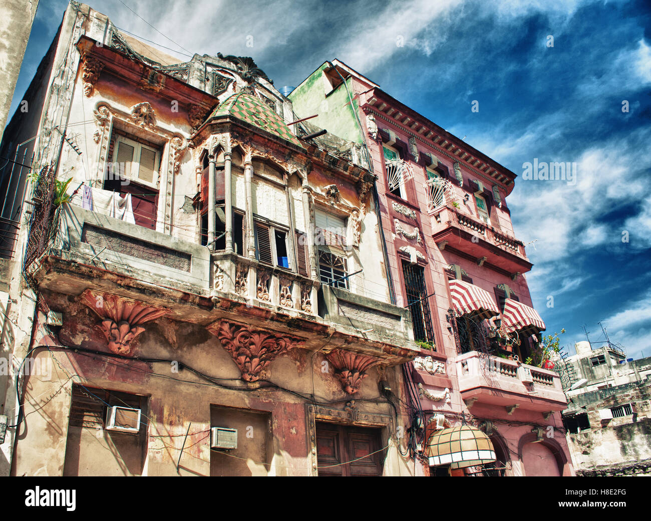 Old Havana colonial building with crumbling balconies against dramatic ...
