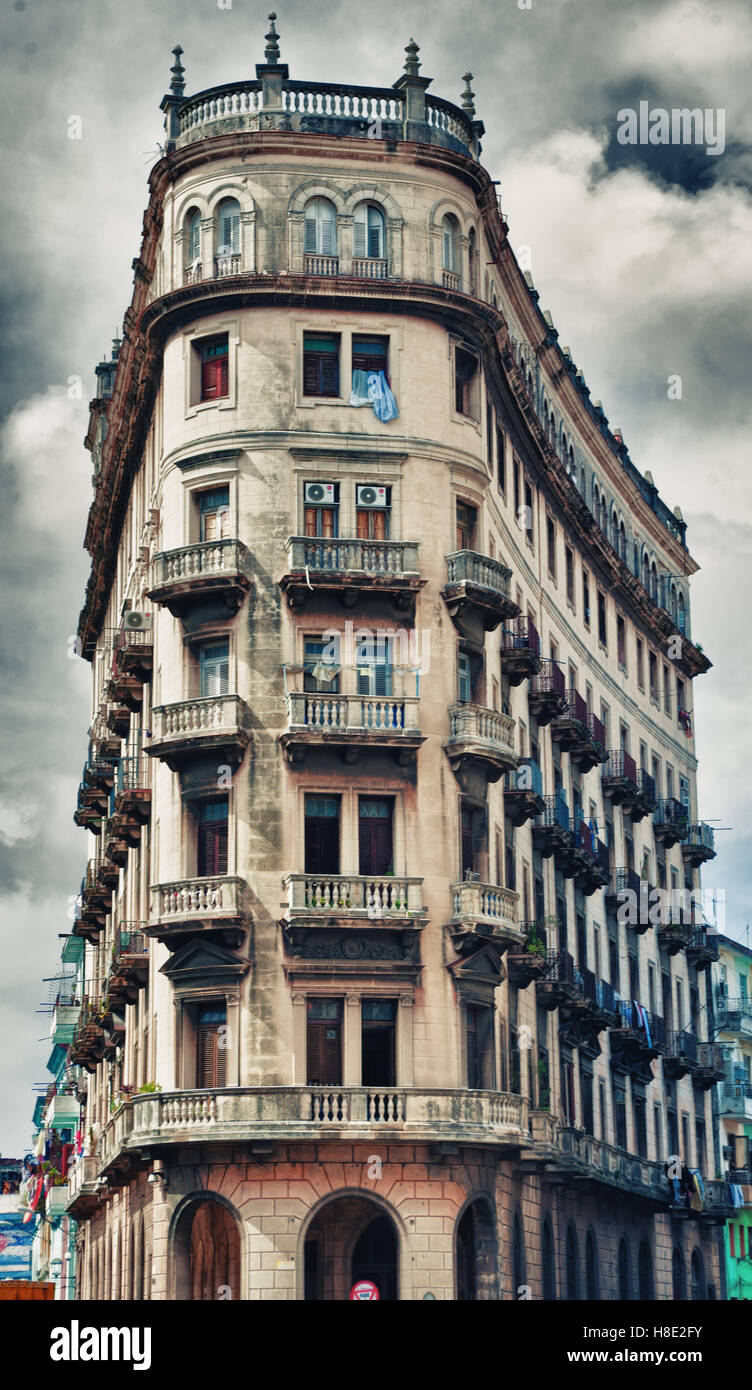 Old Havana colonial high rise building with balconies against dramatic ...