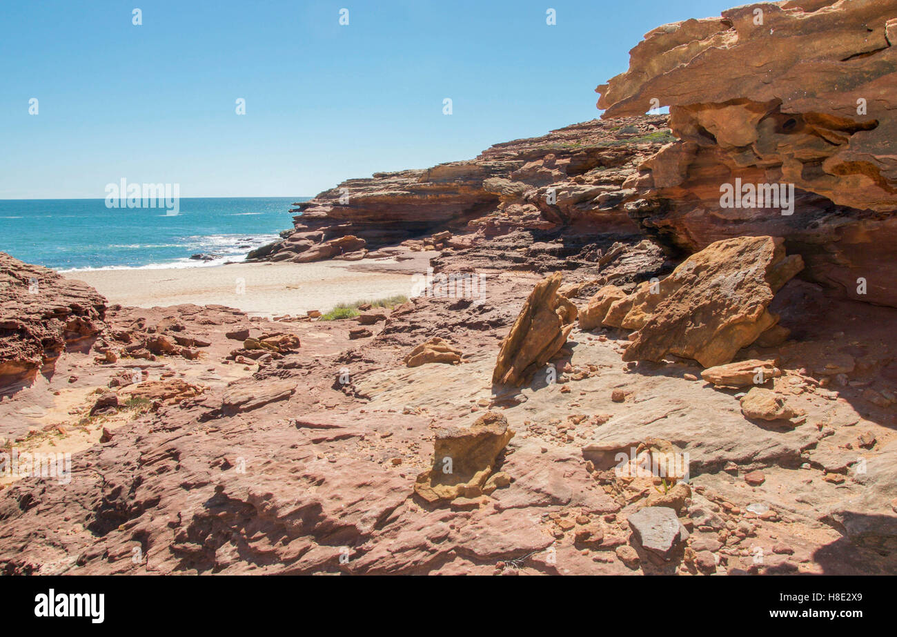 Remote beach at Pot Alley with red sandstone rock and the Indian Ocean ...