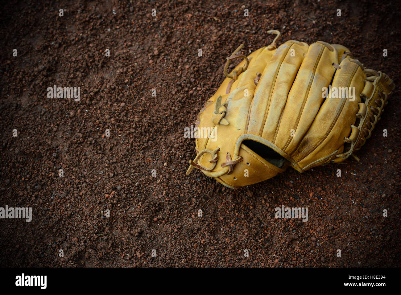 baseball glove on the ground Stock Photo - Alamy