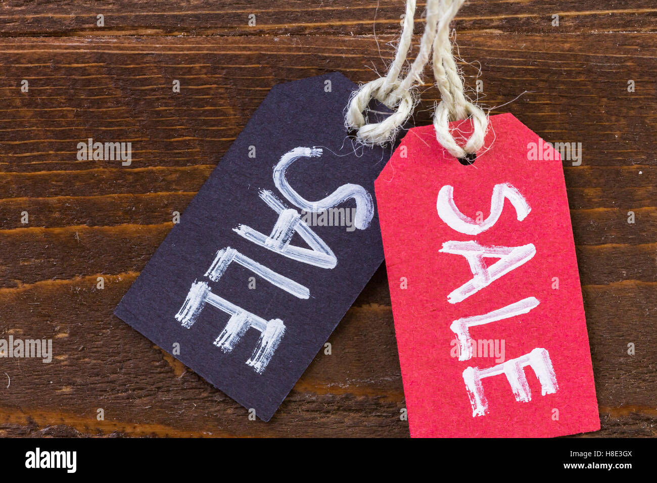 Tags with sale sign on wood board Stock Photo - Alamy