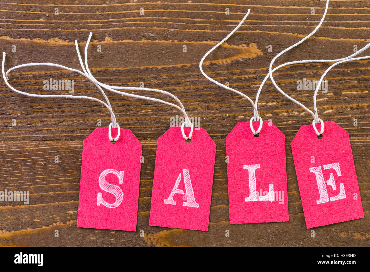 Tags with sale sign on wood board Stock Photo - Alamy