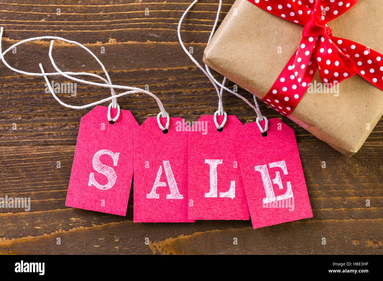 Tags with sale sign on wood board Stock Photo - Alamy