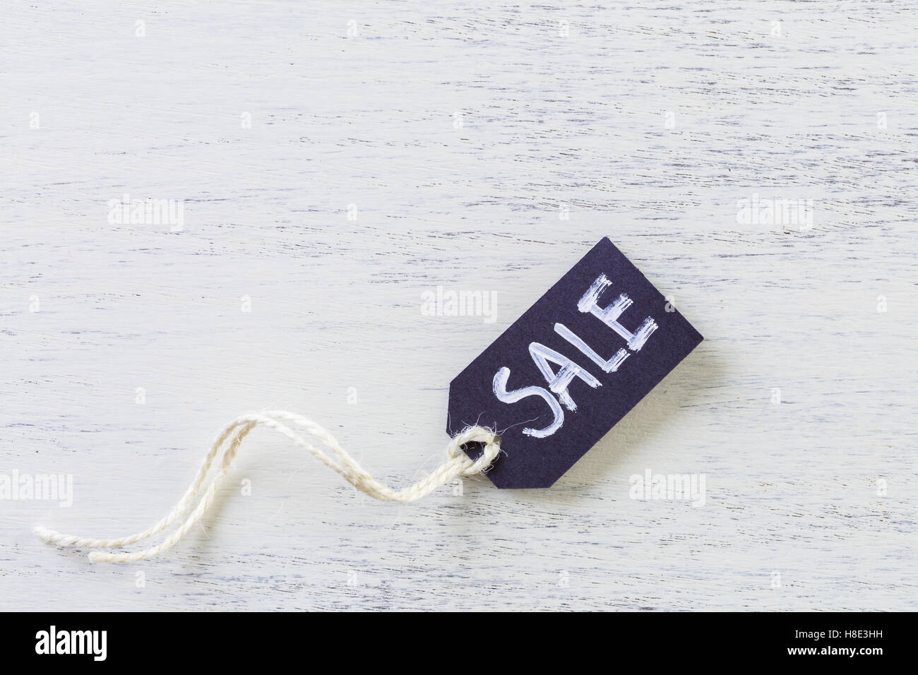 Tags with sale sign on wood board Stock Photo - Alamy