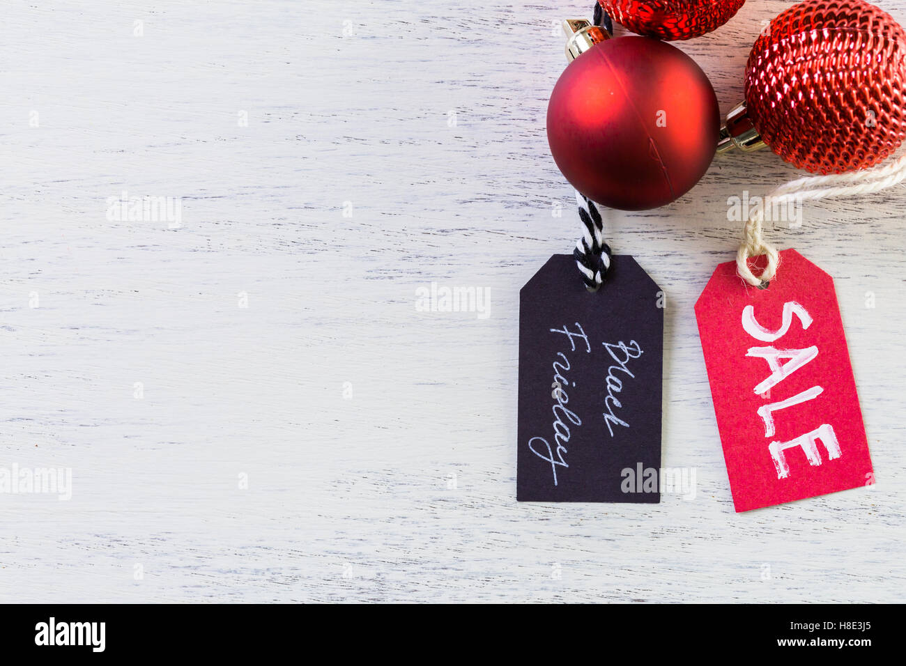 Tags with sale sign on wood board Stock Photo - Alamy