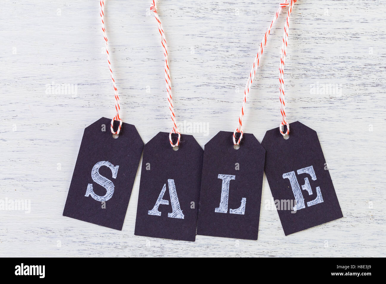 Tags with sale sign on wood board Stock Photo - Alamy
