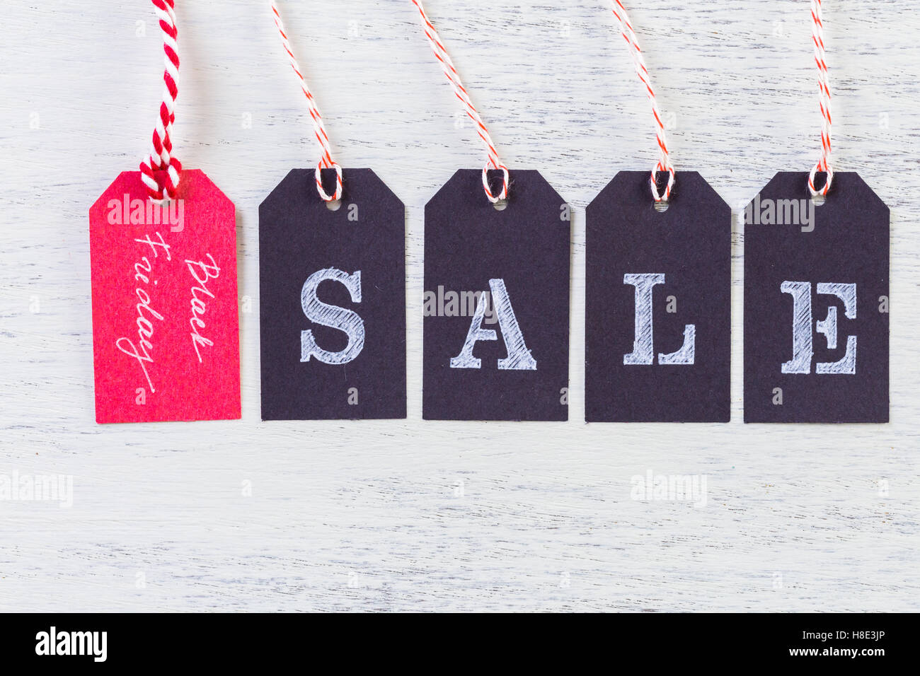 Tags with sale sign on wood board Stock Photo - Alamy