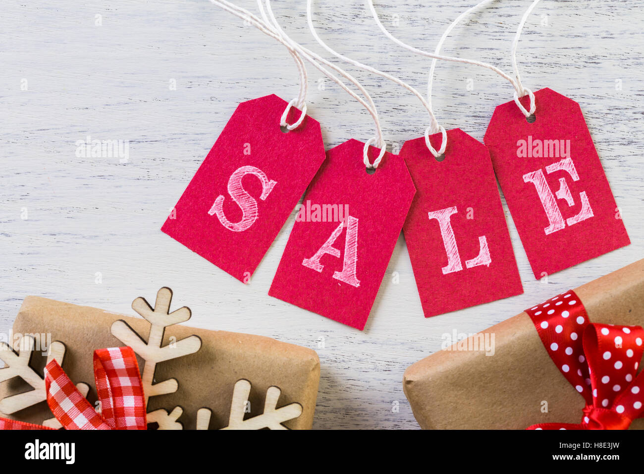 Tags with sale sign on wood board Stock Photo - Alamy