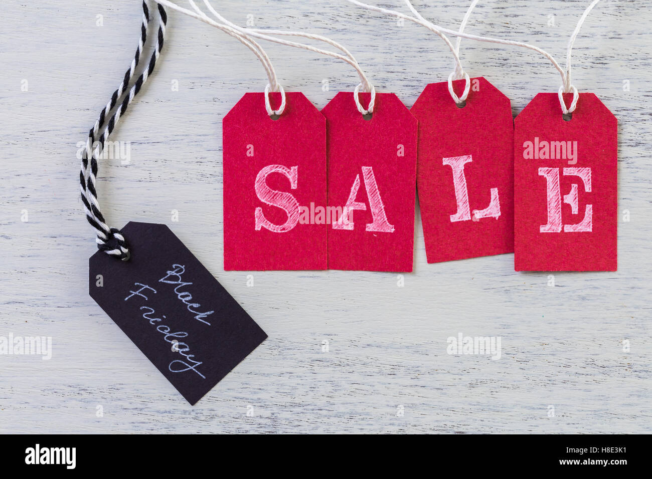 Tags with sale sign on wood board Stock Photo - Alamy