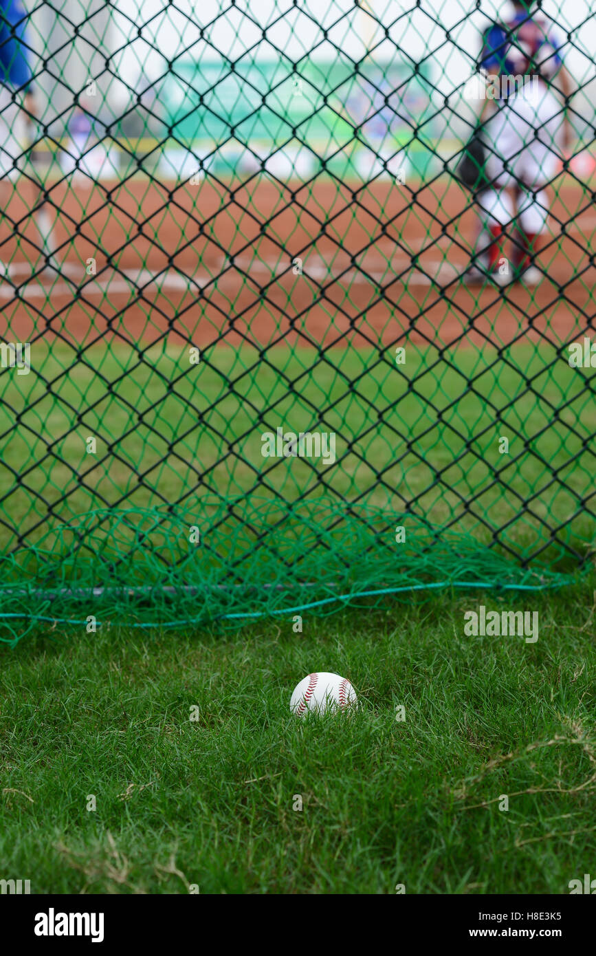 baseball outside of a baseball field with batter and catcher at ...
