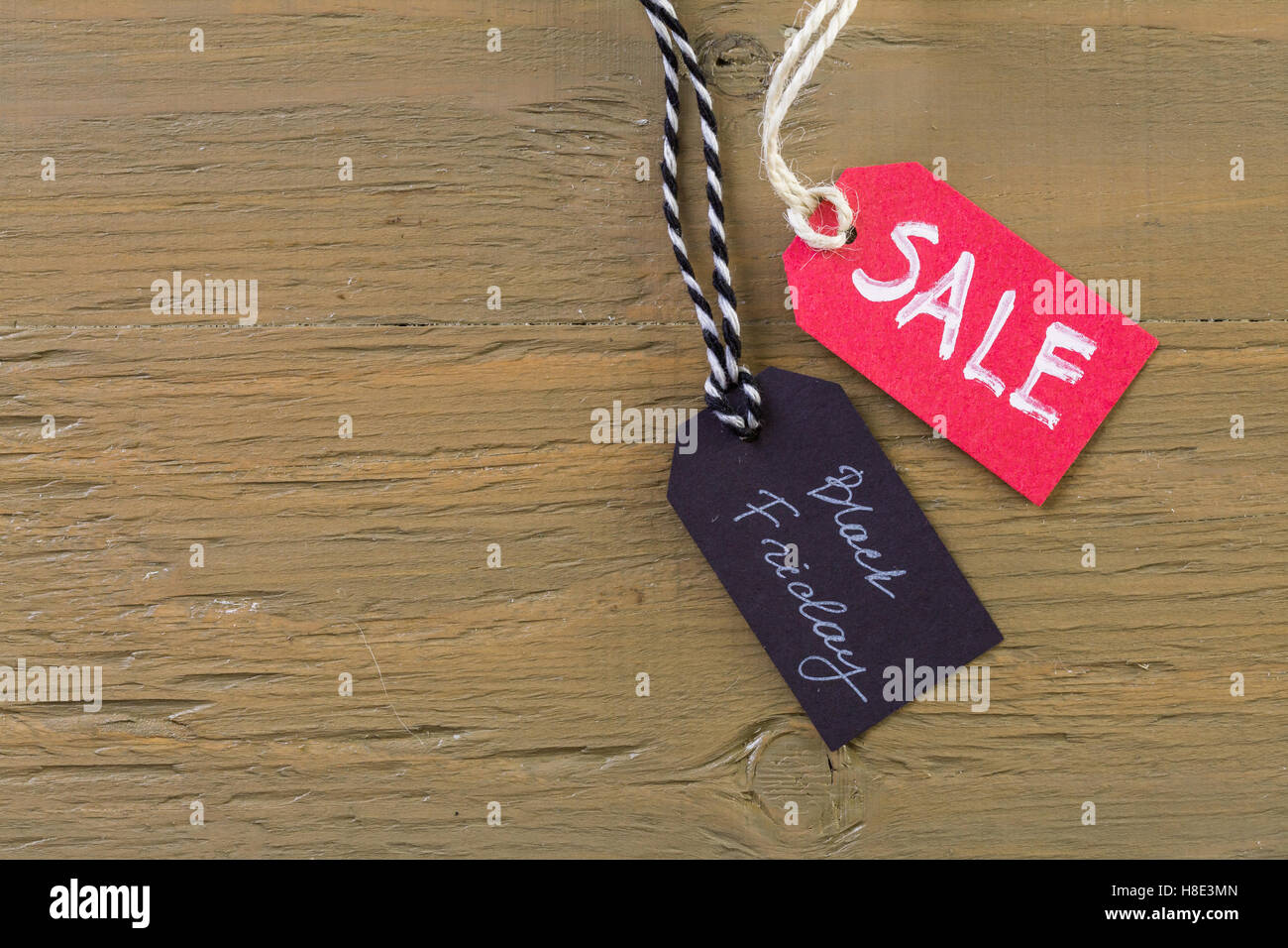 Tags with sale sign on wood board Stock Photo - Alamy