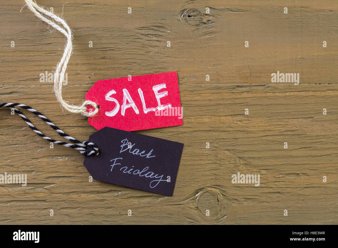 Tags with sale sign on wood board Stock Photo - Alamy