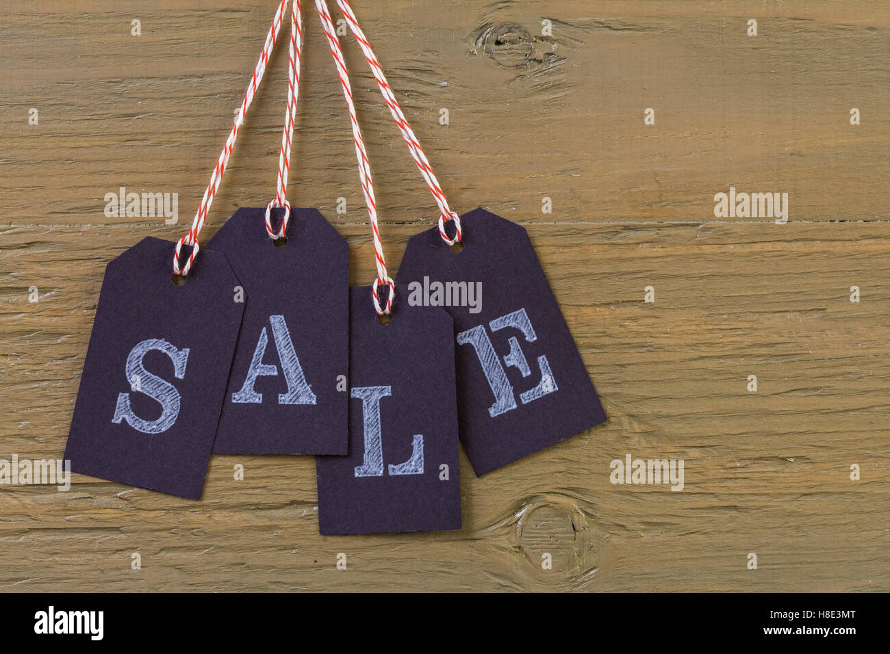 Tags with sale sign on wood board Stock Photo - Alamy