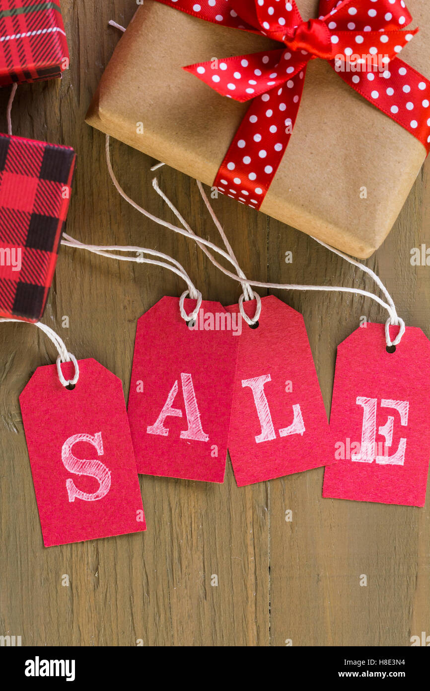 Tags with sale sign on wood board Stock Photo - Alamy