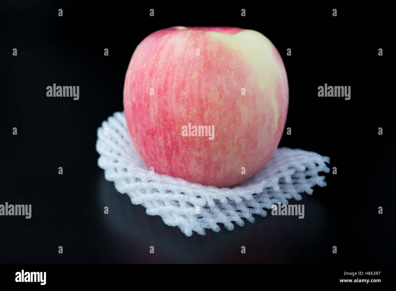 fresh apple on a protective foam on black background Stock Photo - Alamy