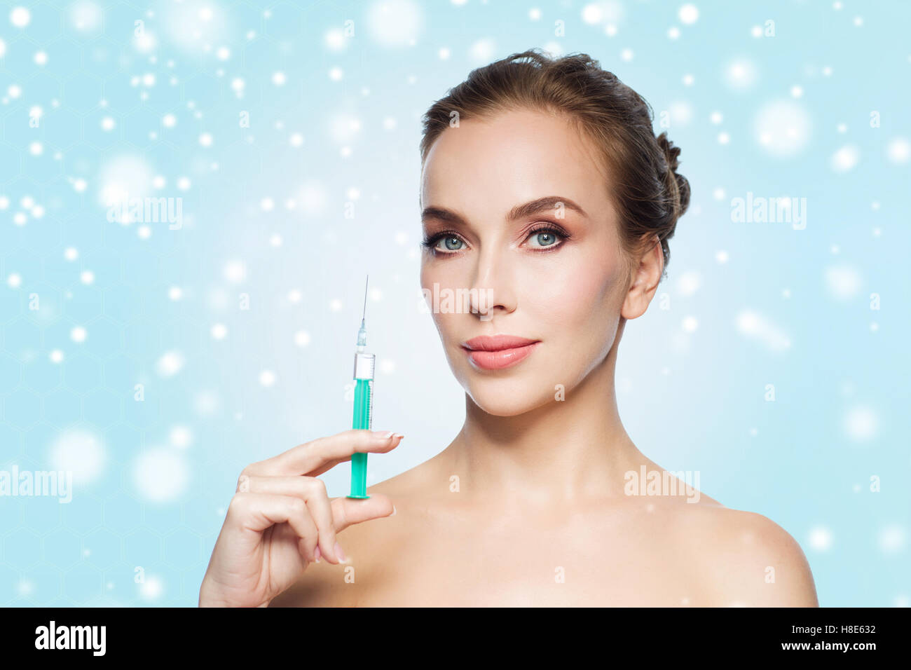 beautiful woman holding syringe with injection Stock Photo - Alamy