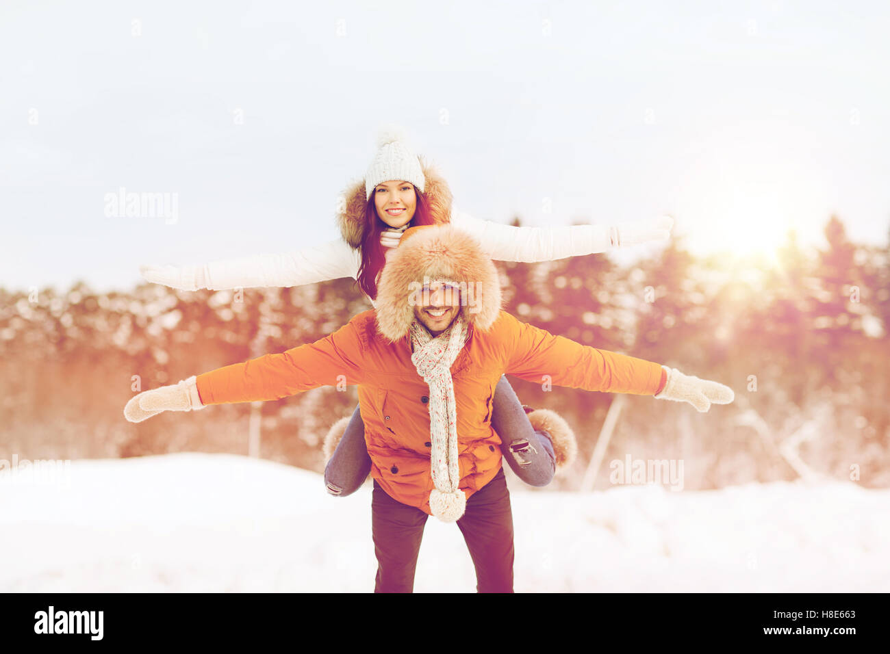 happy couple having fun over winter background Stock Photo - Alamy
