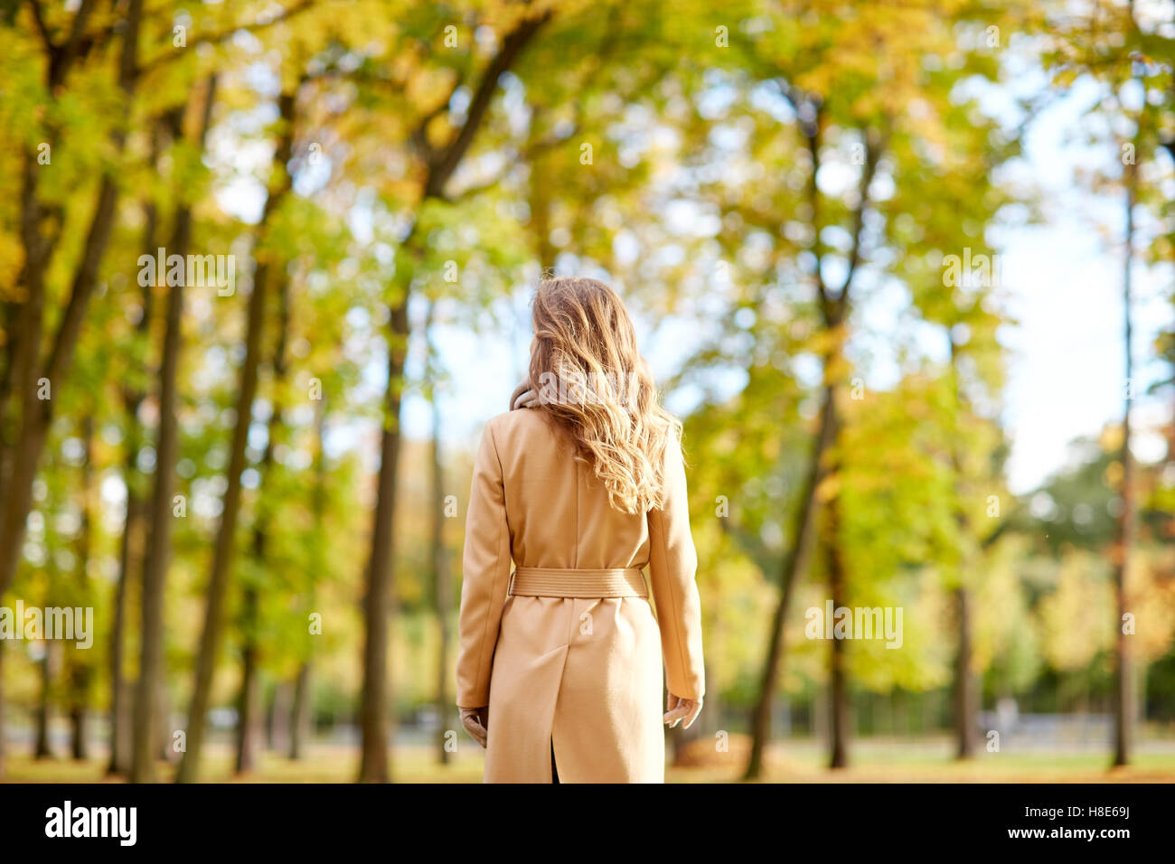 beautiful young woman walking in autumn park Stock Photo - Alamy