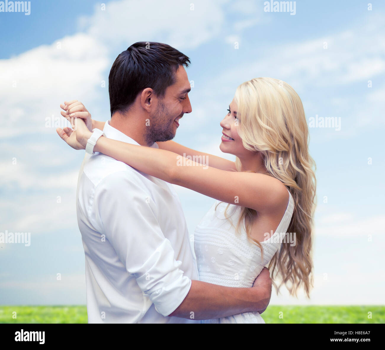 happy couple hugging over natural background Stock Photo - Alamy