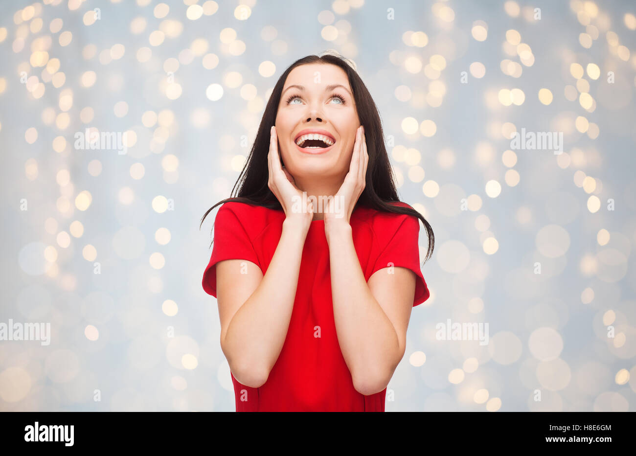 amazed laughing young woman in red dress Stock Photo - Alamy