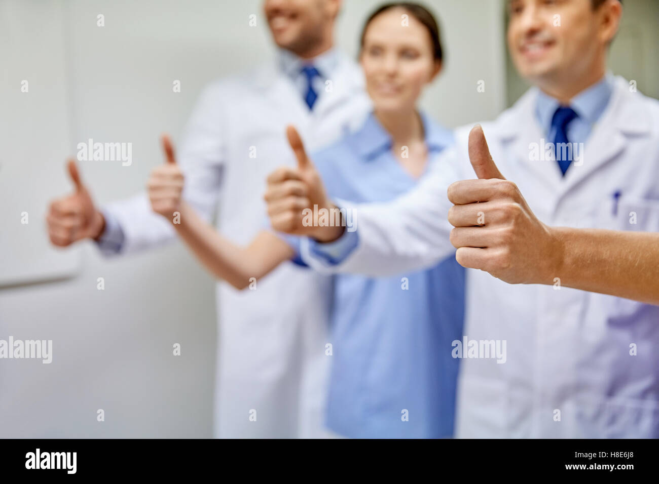 close up of doctors at hospital showing thumbs Stock Photo - Alamy