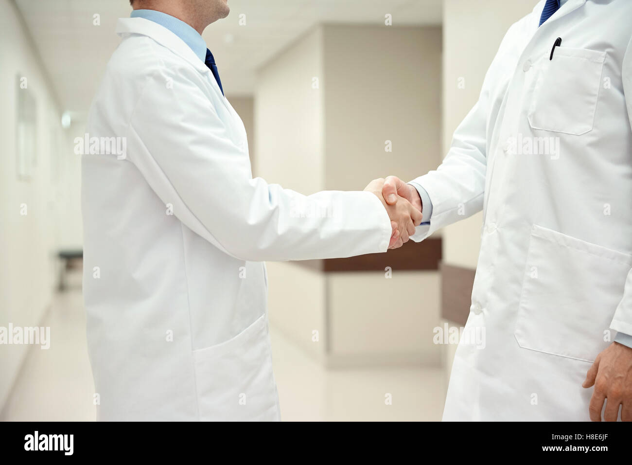 close up of doctors making handshake Stock Photo - Alamy