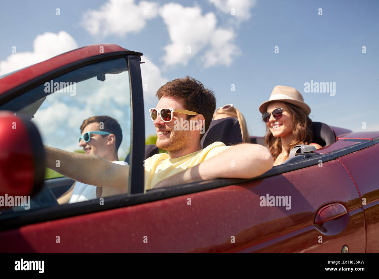 happy friends driving in cabriolet car Stock Photo - Alamy