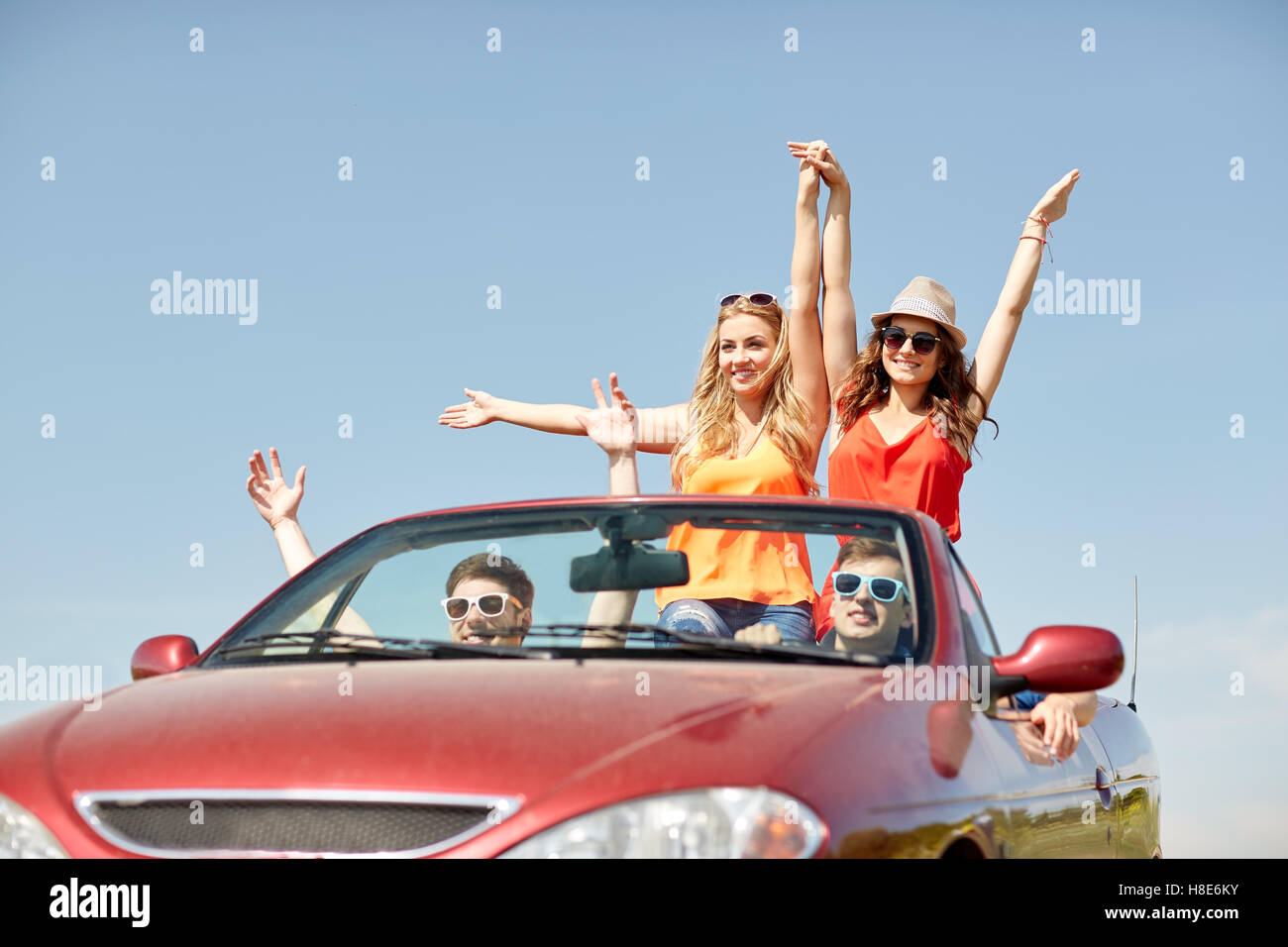 happy friends driving in cabriolet car at country Stock Photo - Alamy