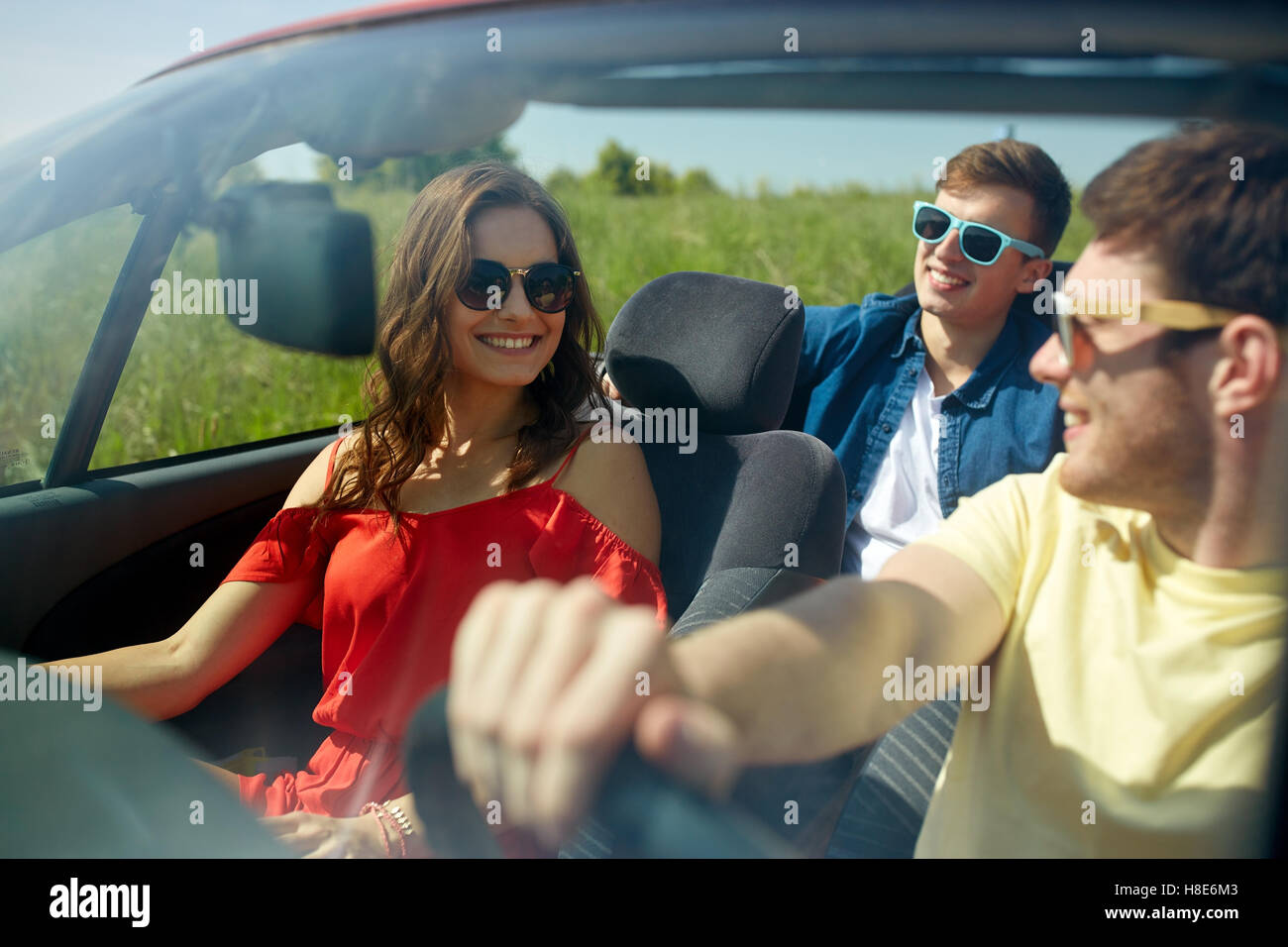 happy friends driving in cabriolet car Stock Photo - Alamy