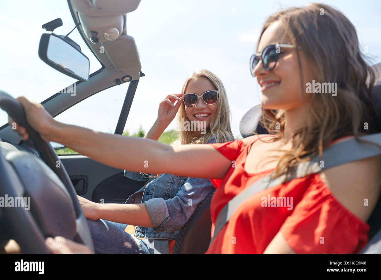 smiling young women driving in cabriolet car Stock Photo - Alamy