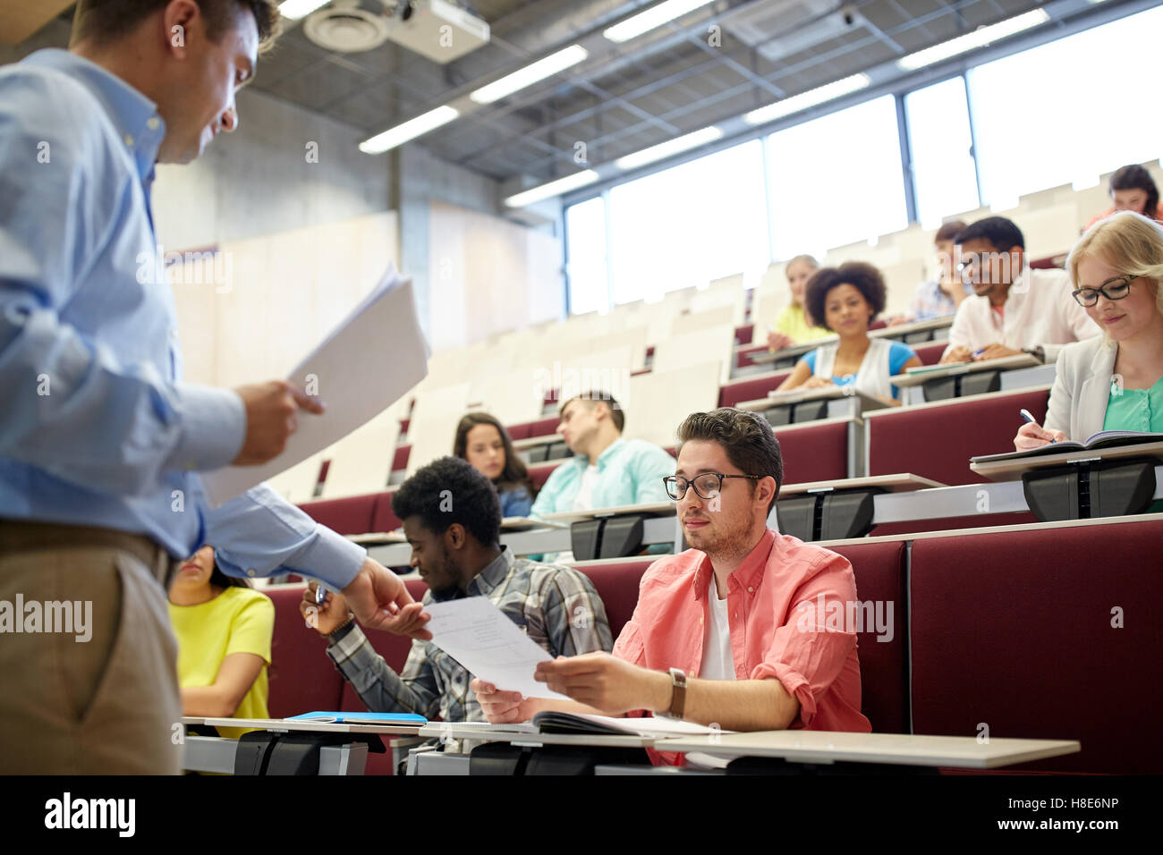 teacher giving tests to students at lecture Stock Photo - Alamy