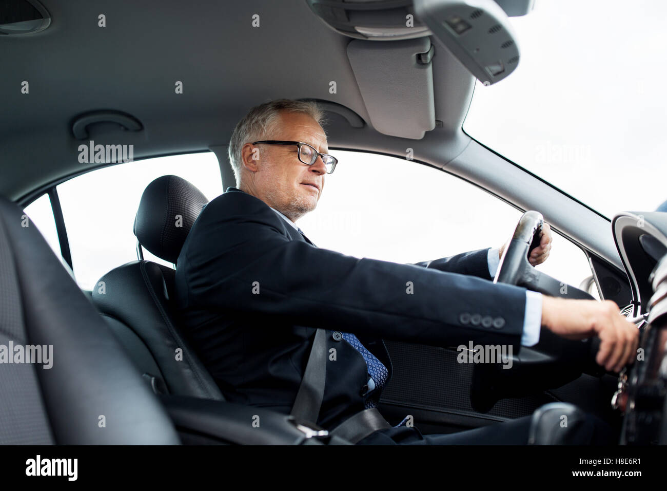 happy senior businessman starting car and driving Stock Photo - Alamy