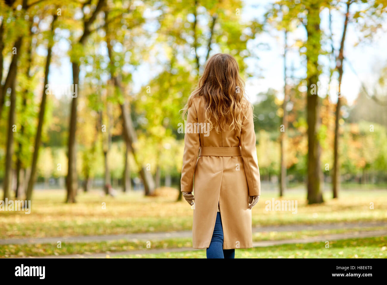 beautiful young woman walking in autumn park Stock Photo - Alamy