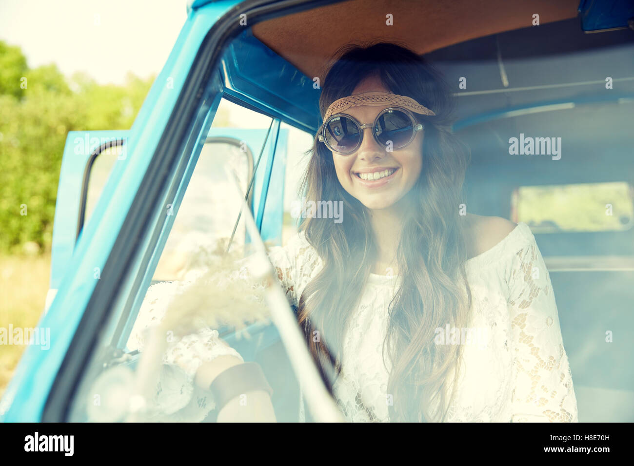 smiling young hippie woman in minivan car Stock Photo - Alamy