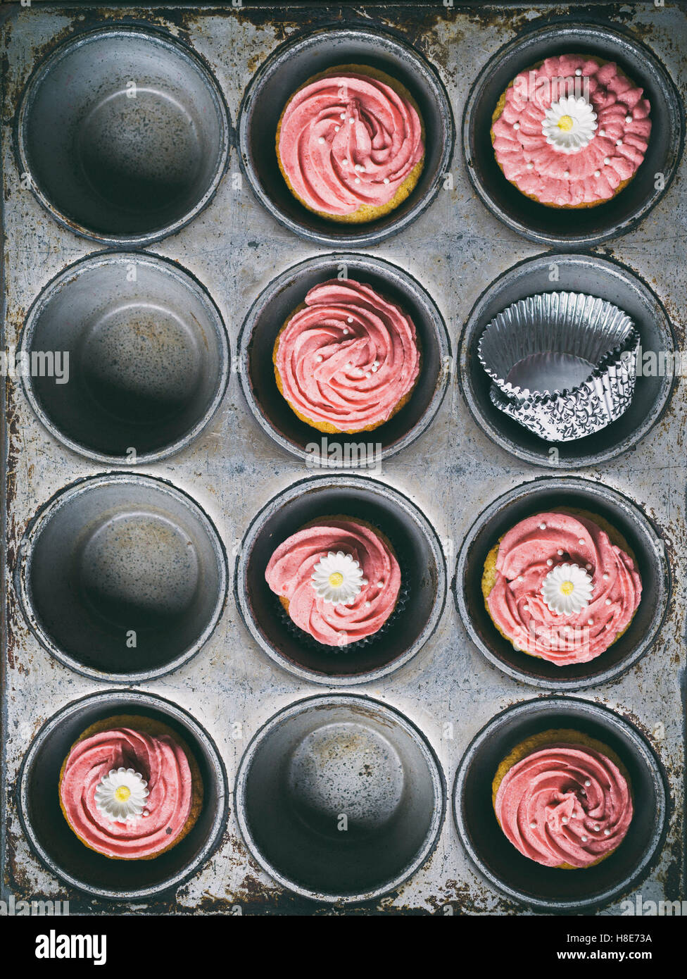 Pink iced cupcakes in a baking tray Stock Photo - Alamy