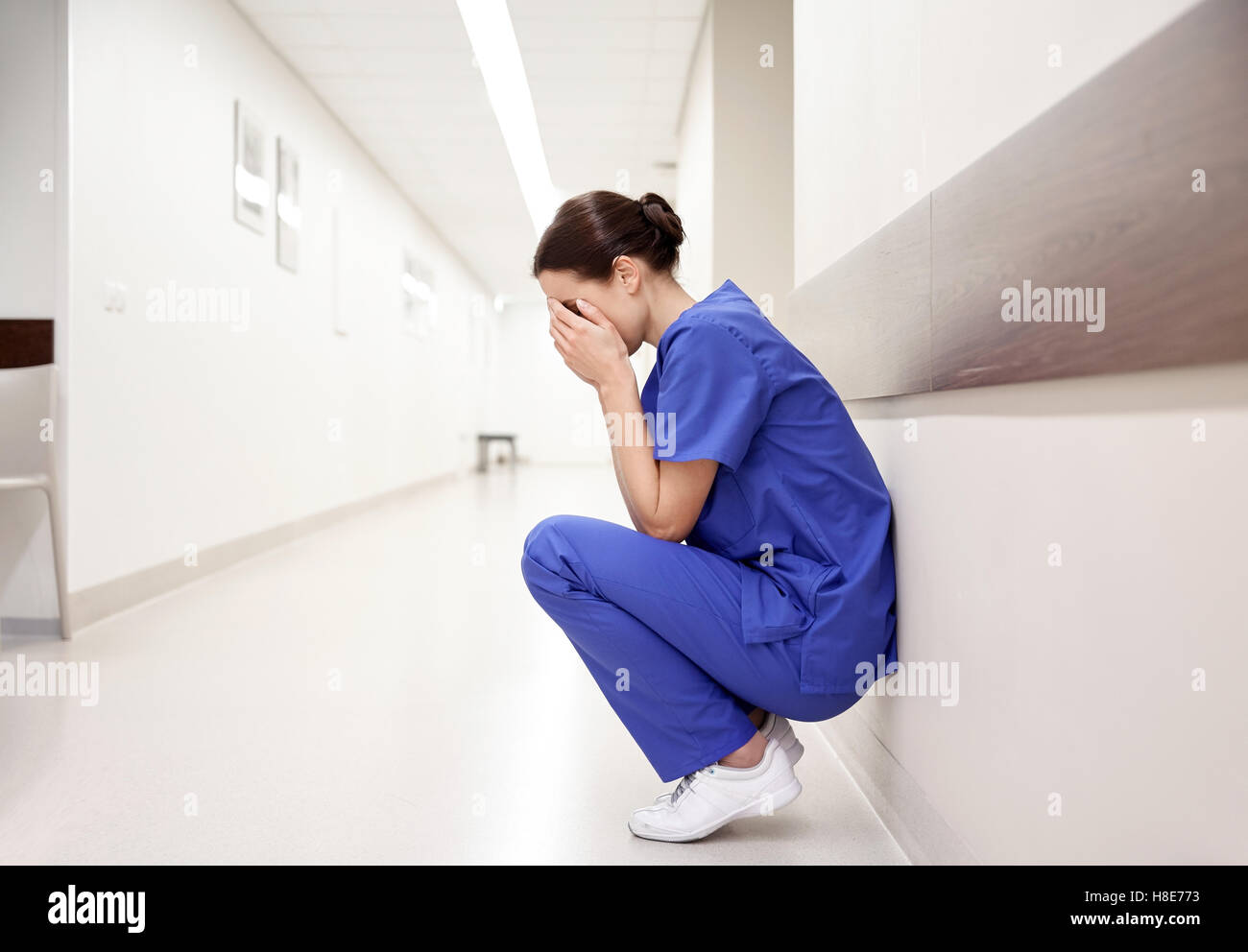 sad or crying female nurse at hospital corridor Stock Photo - Alamy