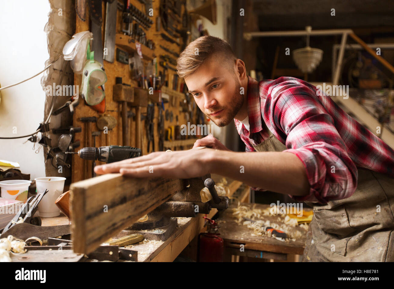 carpenter working with wood plank at workshop Stock Photo - Alamy