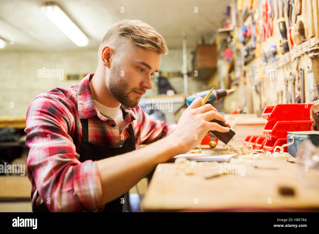 carpenter working with wood plank at workshop Stock Photo - Alamy