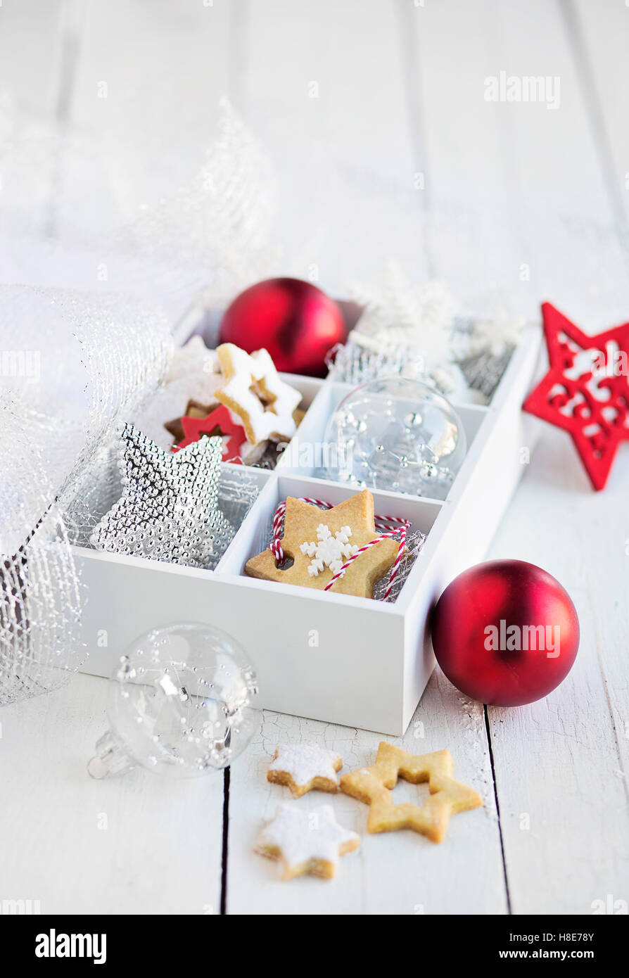 Box with christmas biscuits and decorations on white table Stock Photo ...