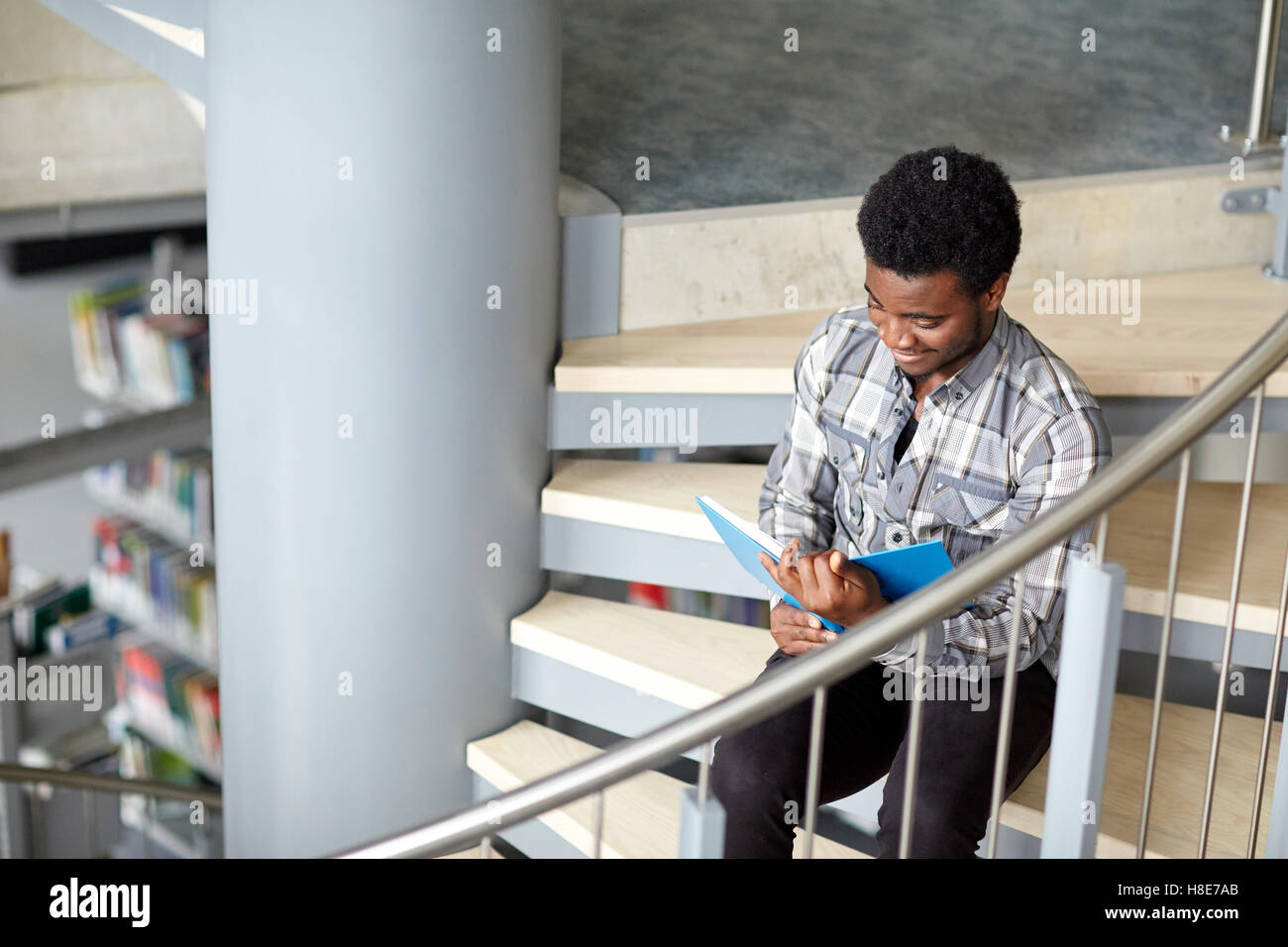 african student boy or man reading book at library Stock Photo - Alamy