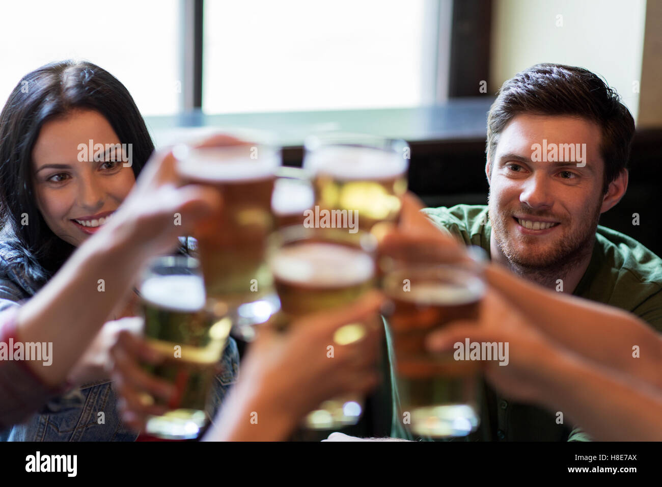 happy friends drinking beer at bar or pub Stock Photo - Alamy